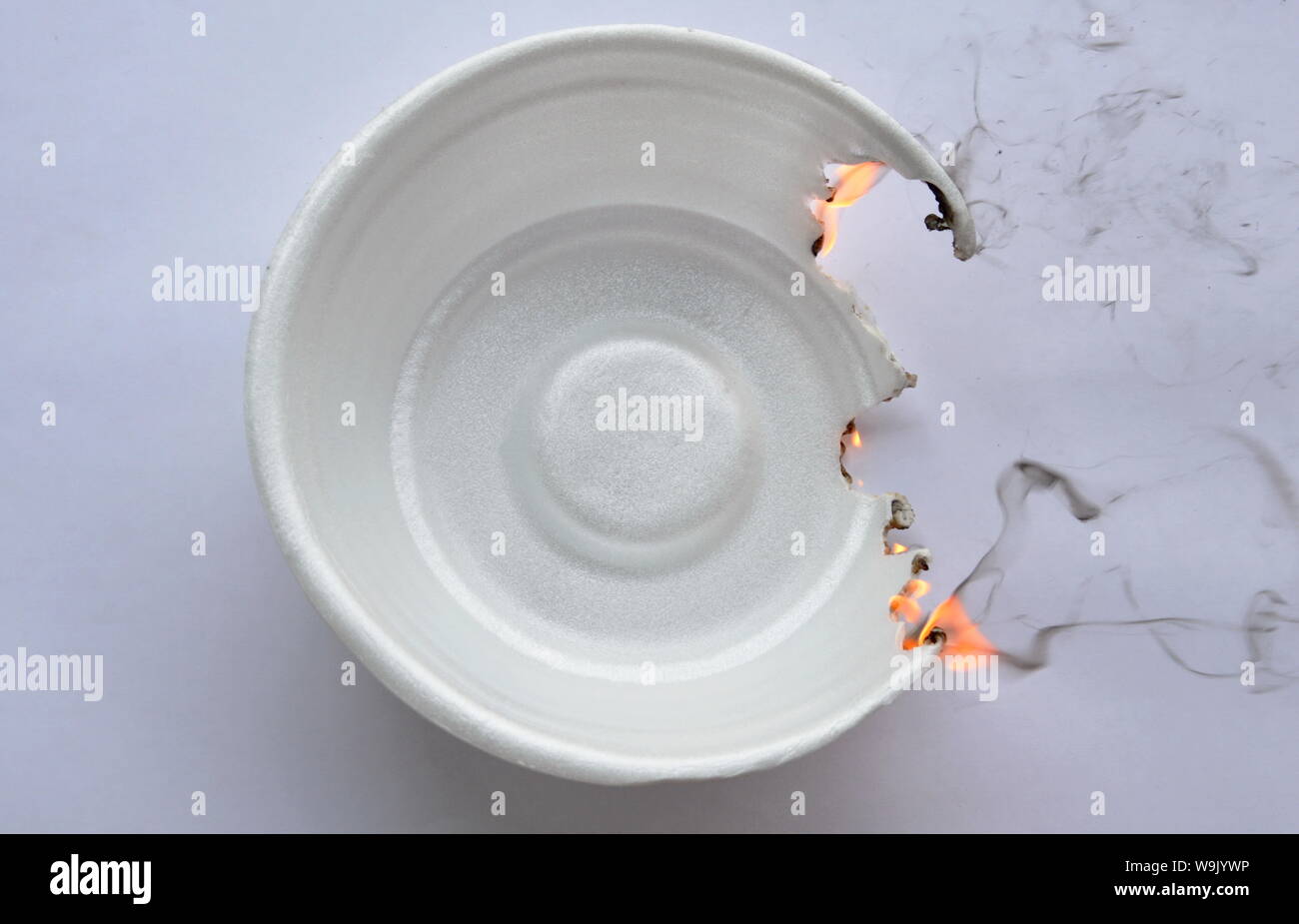 foam bowl burning on white background Stock Photo - Alamy