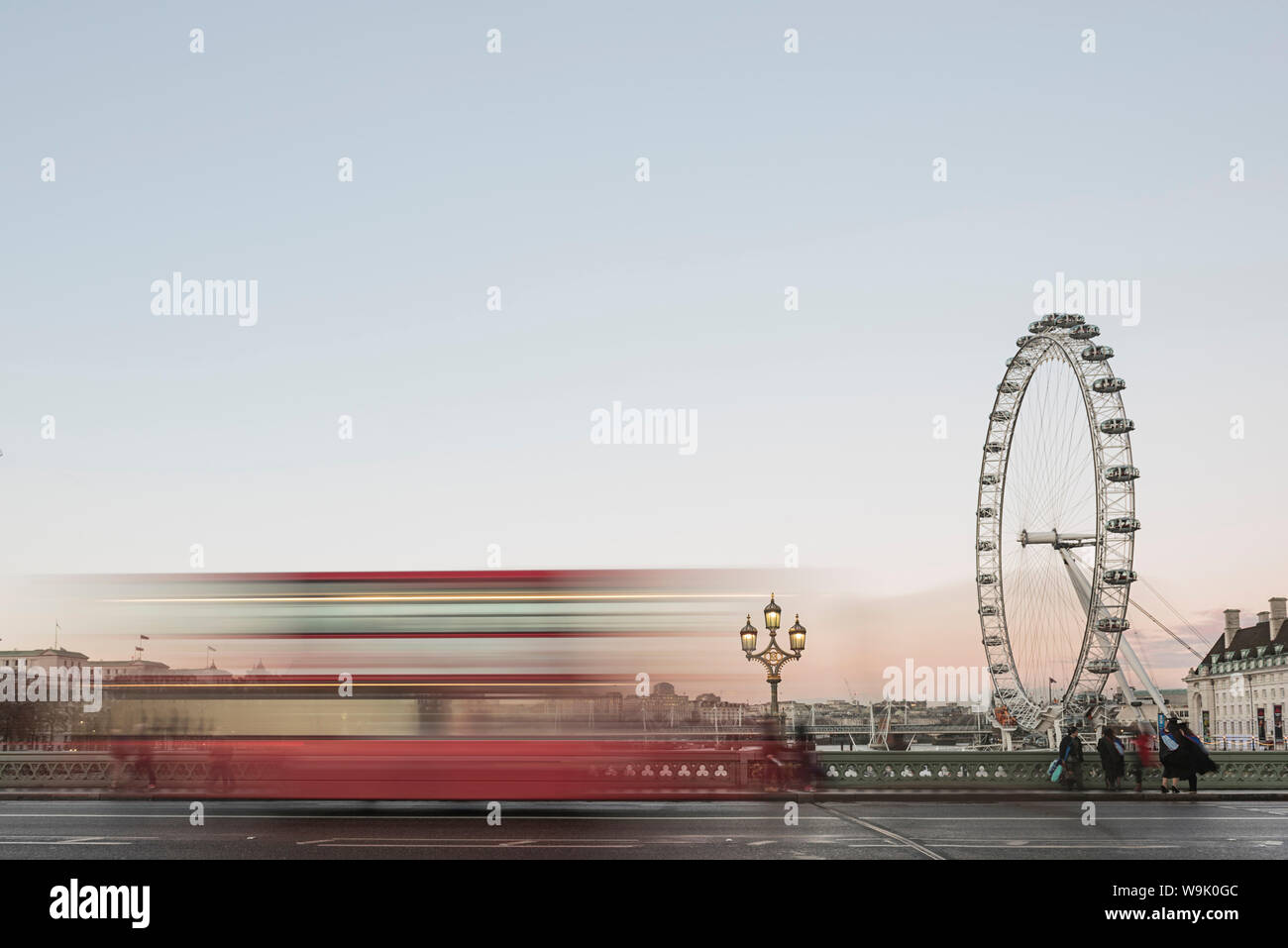 The London Eye, with red London bus on Westminster Bridge at sunset ...