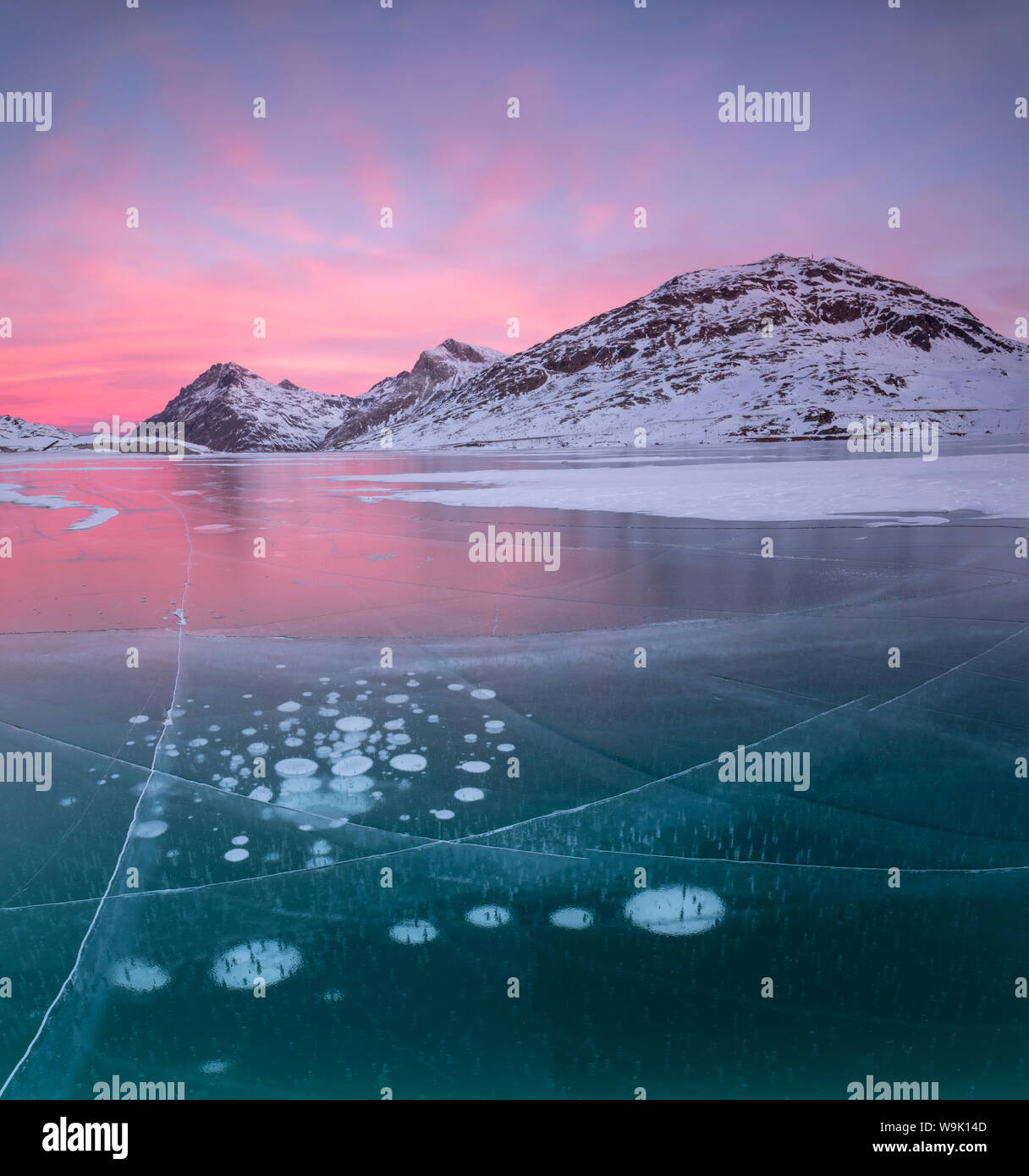 Panorama of ice bubbles and frozen surface of Lago Bianco at dawn ...