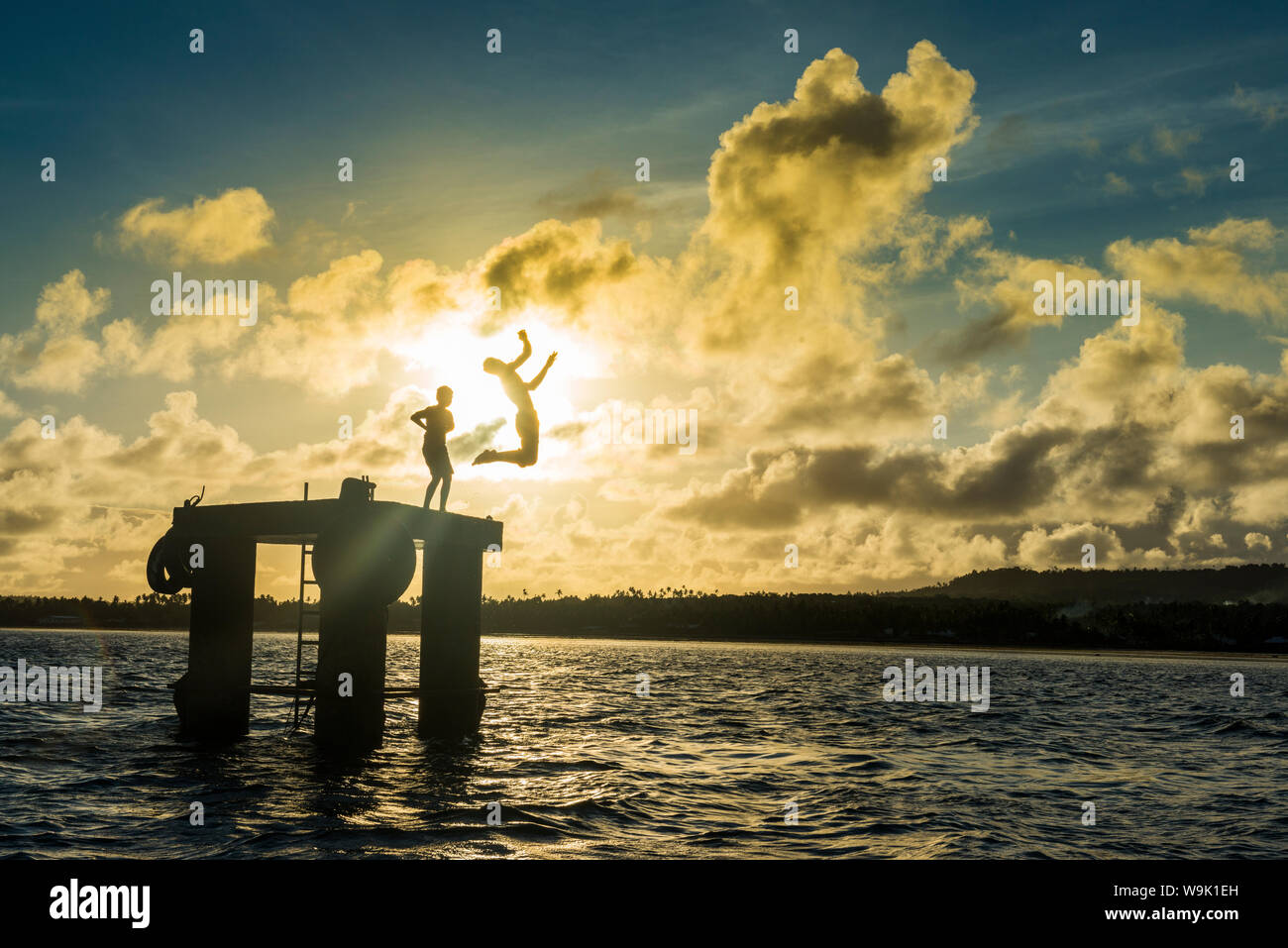 Two boys jumping into the sea hi-res stock photography and images - Alamy