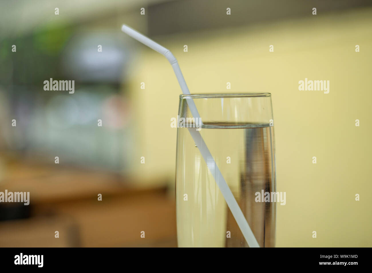 Fizzy drink or water with straw standing on the table in cafe. Summer ...