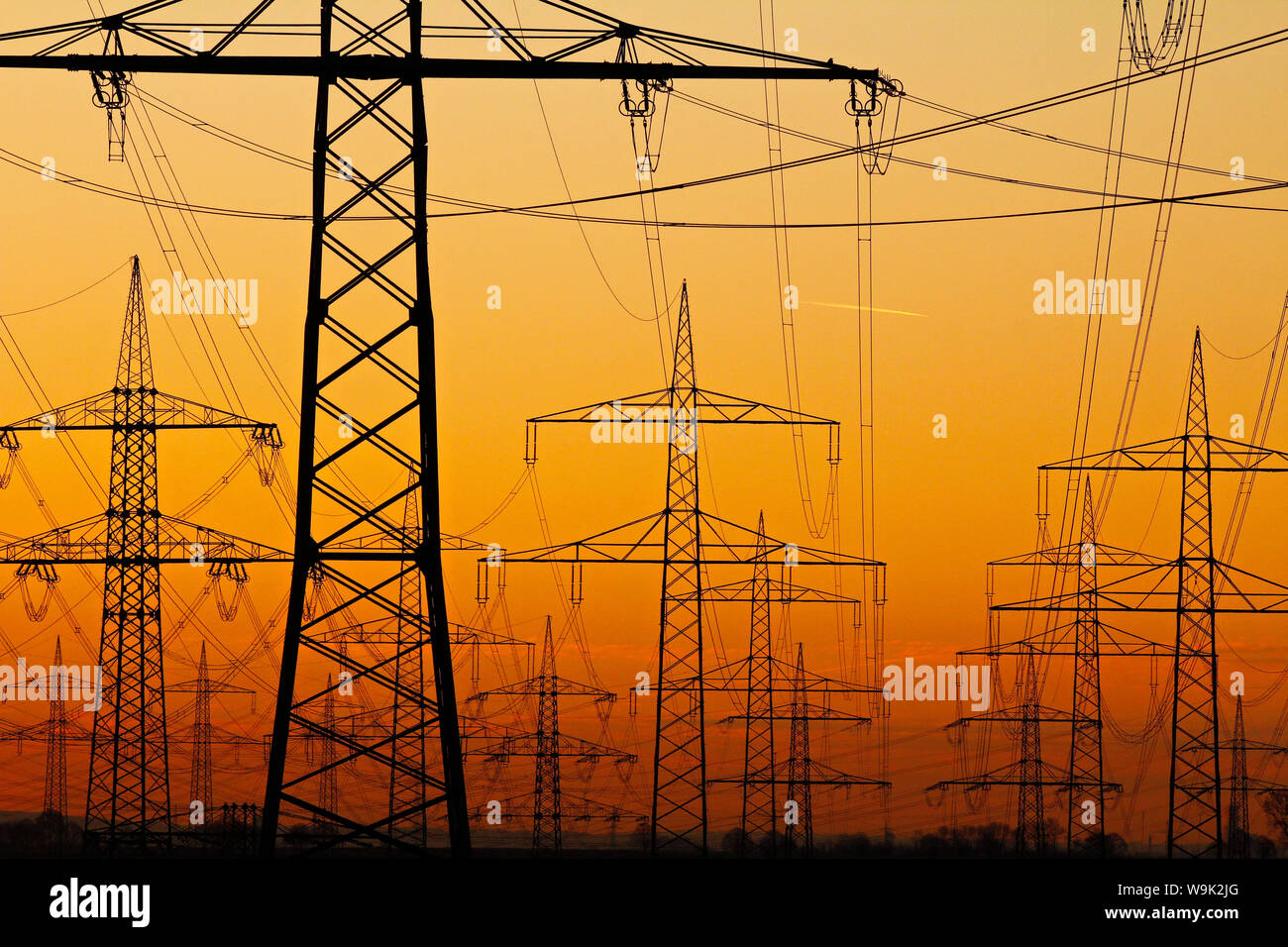 Pylons and power lines in morning light hi-res stock photography and ...