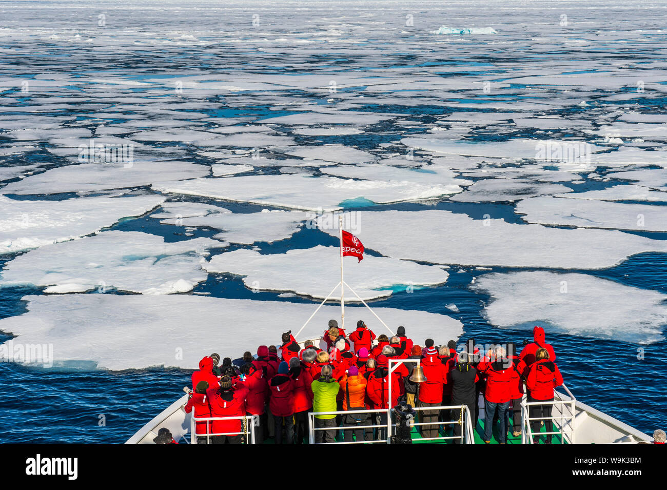 Expedition boat navigating through the pack ice in the Arctic shelf ...