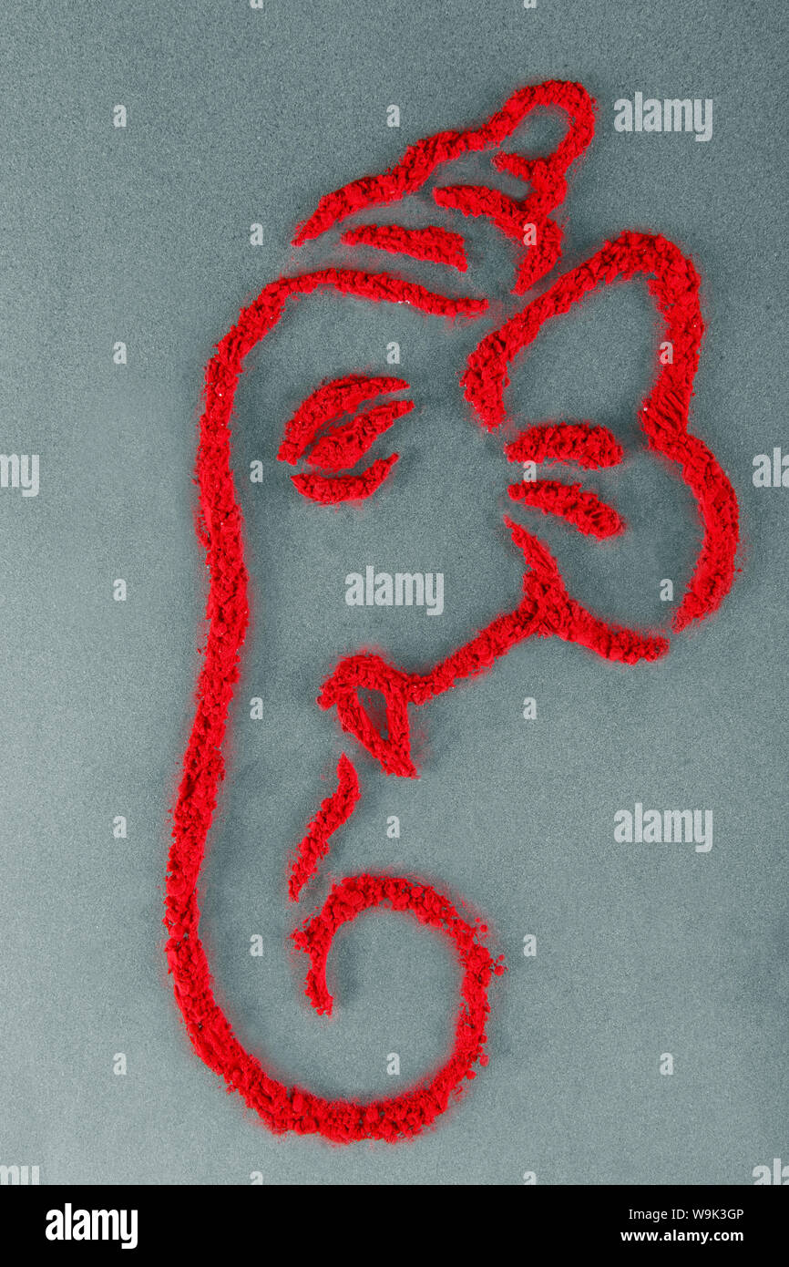 Ganesha symbol made of red powder color Stock Photo - Alamy