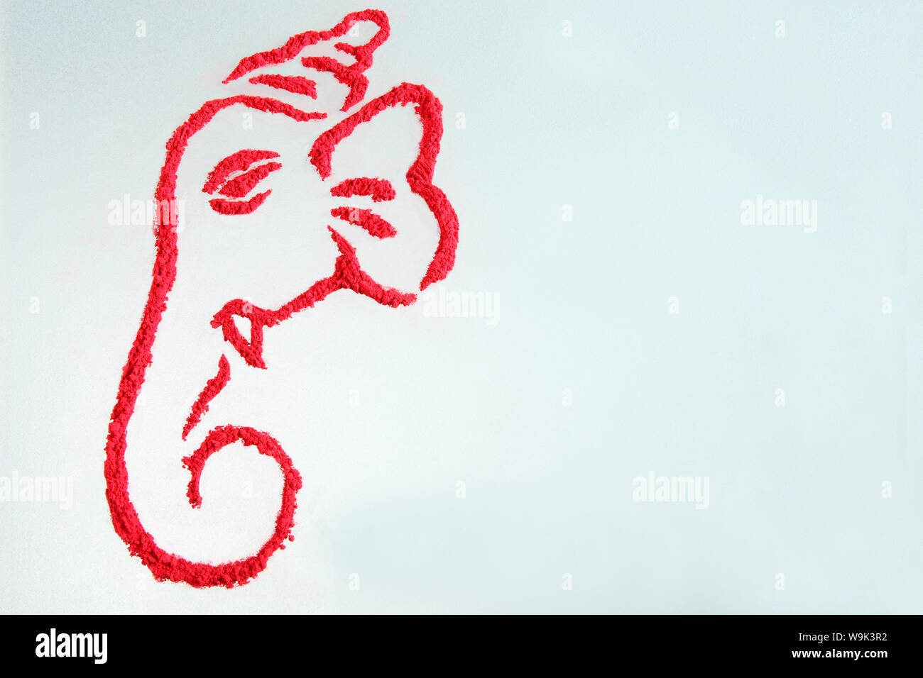 Ganesha symbol made of red powder color Stock Photo - Alamy