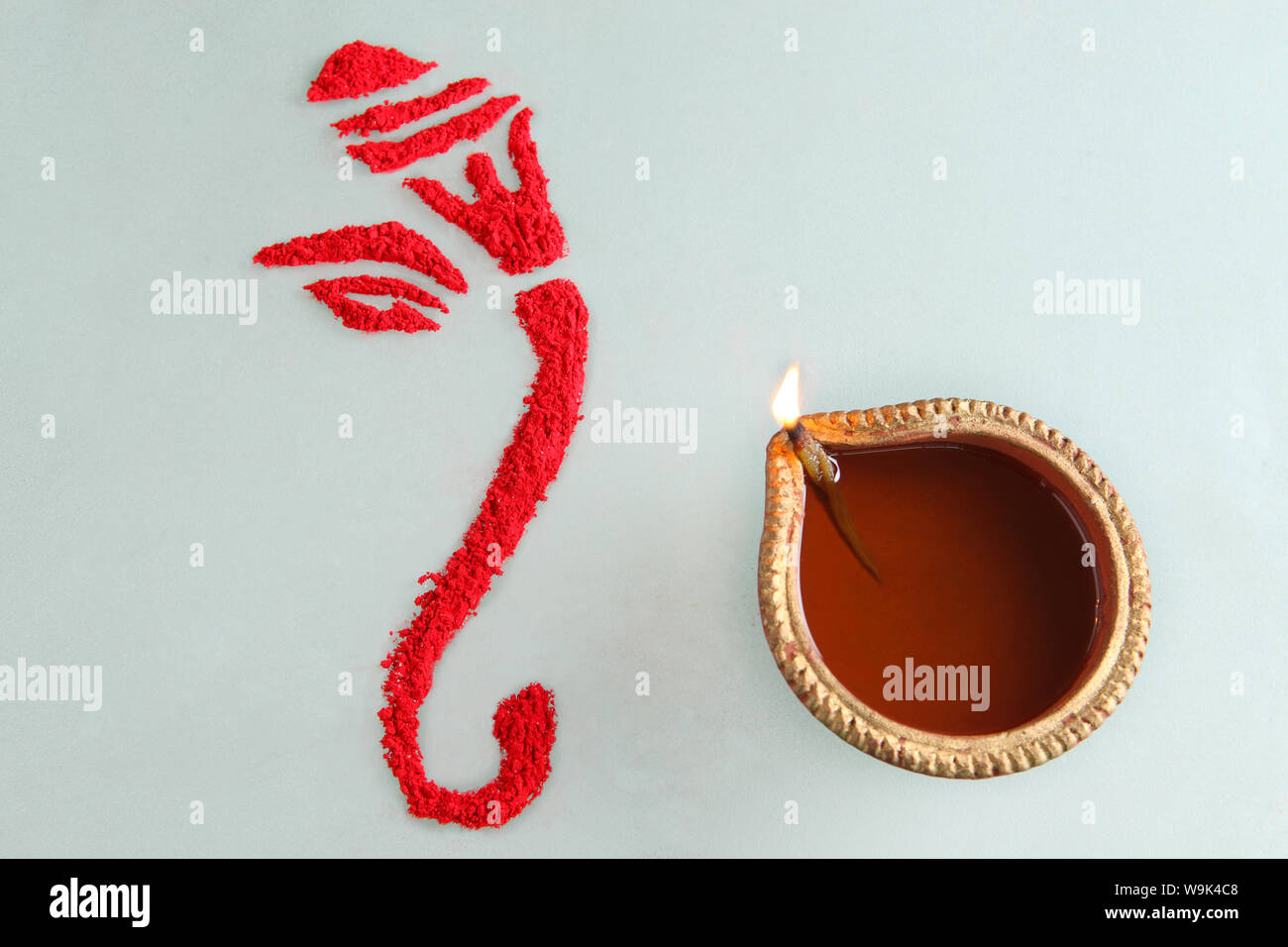 Ganesha symbol made of red powder color Stock Photo - Alamy
