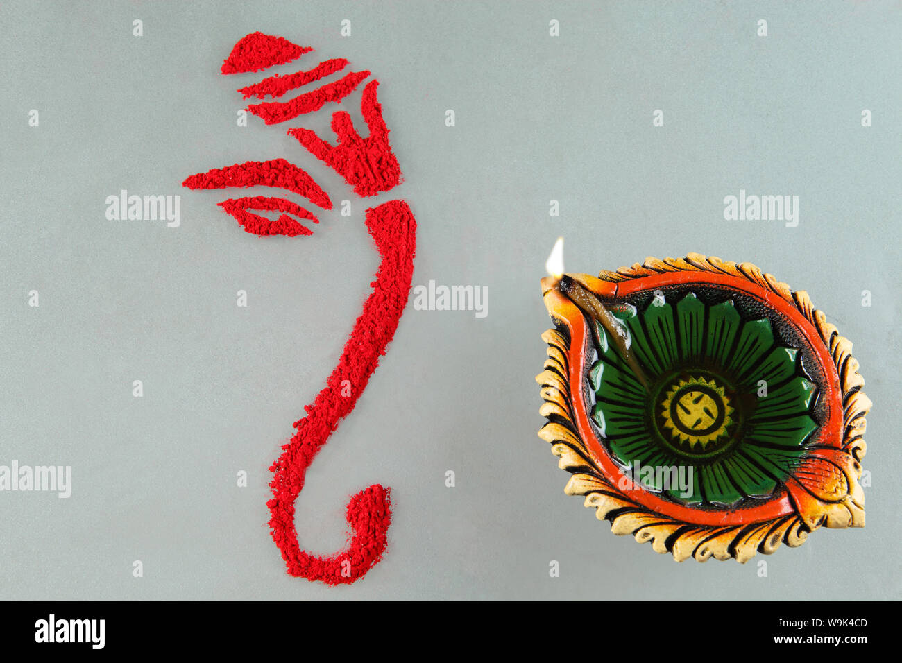 Ganesha symbol made of red powder color Stock Photo - Alamy