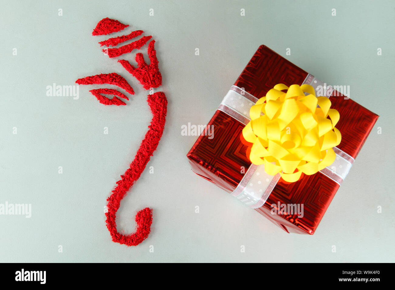 Ganesha symbol made of red powder color Stock Photo - Alamy