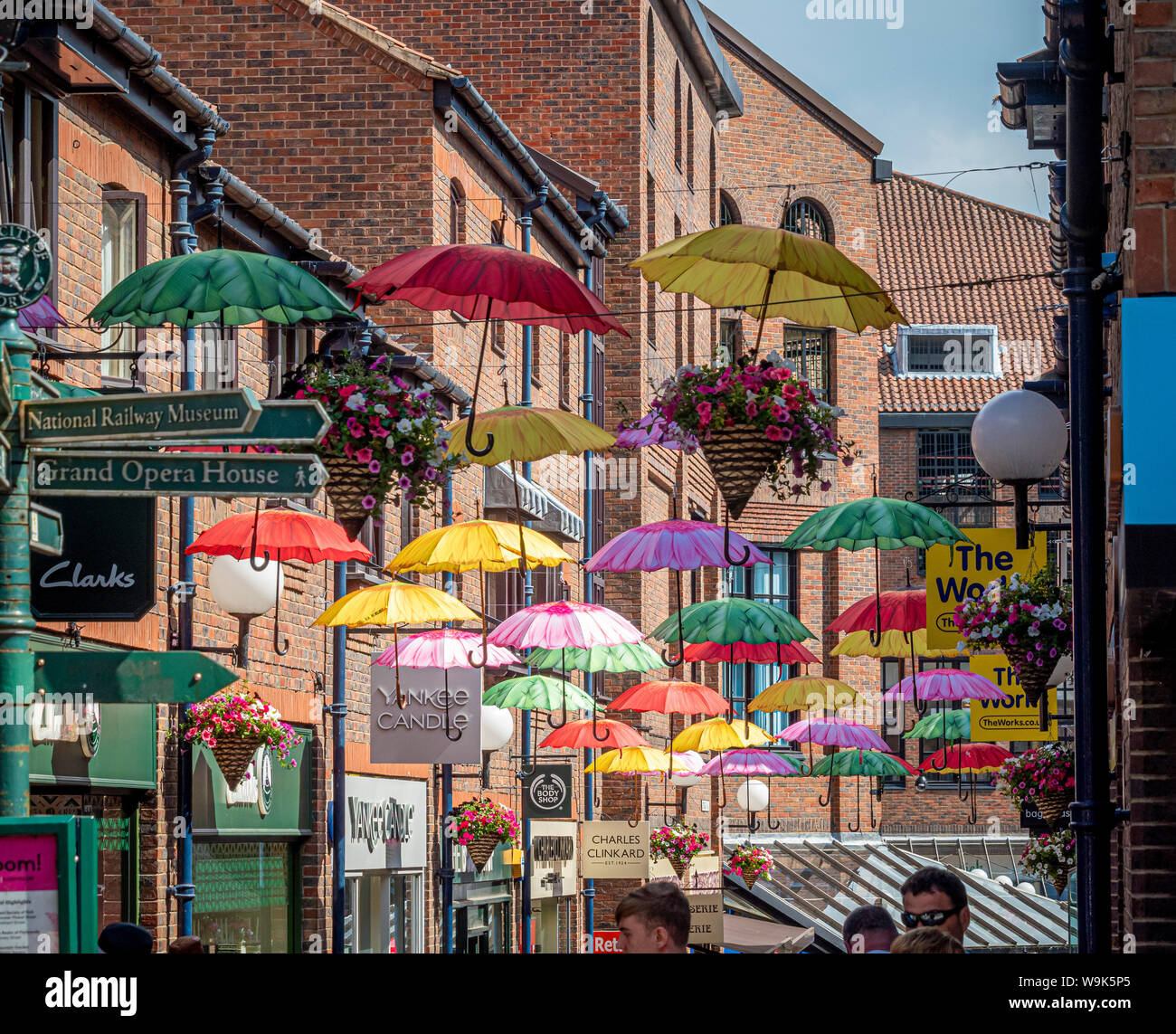 Coloured umbrellas suspended above shoppers in Coppergate shopping ...