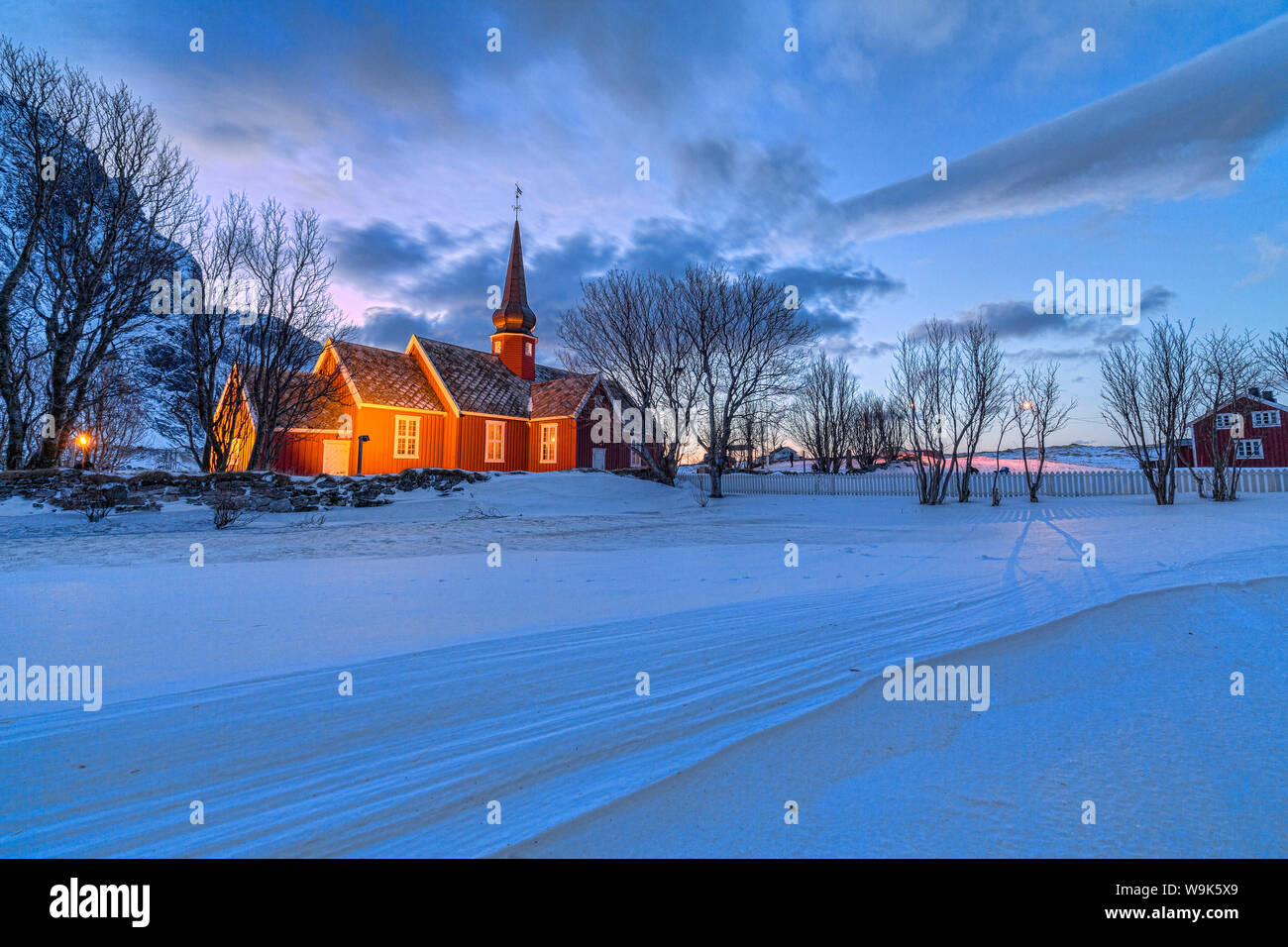 The red church of Flakstad surrounded by snow at dusk, Lofoten Islands ...