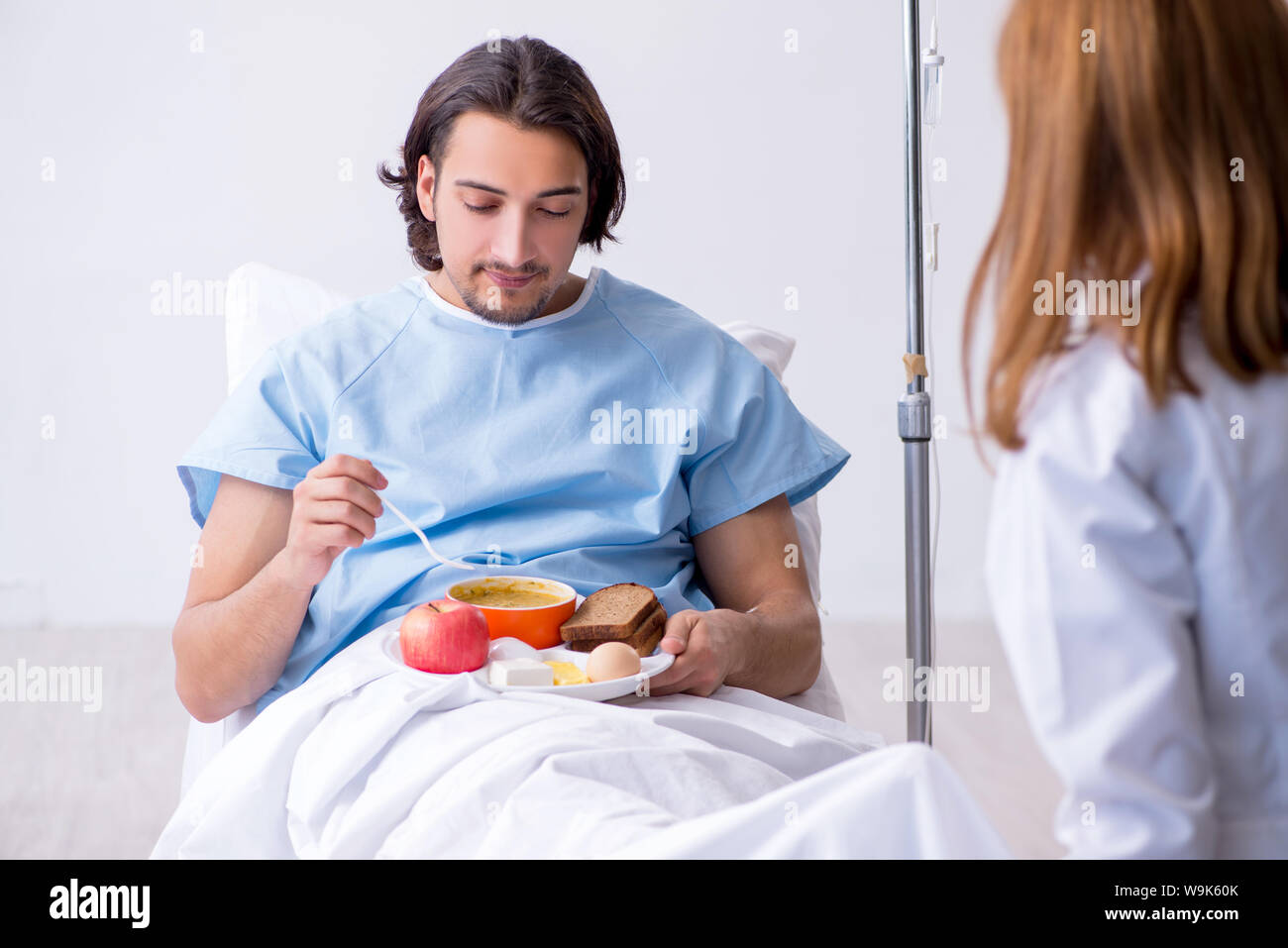 The male patient eating food in the hospital Stock Photo - Alamy