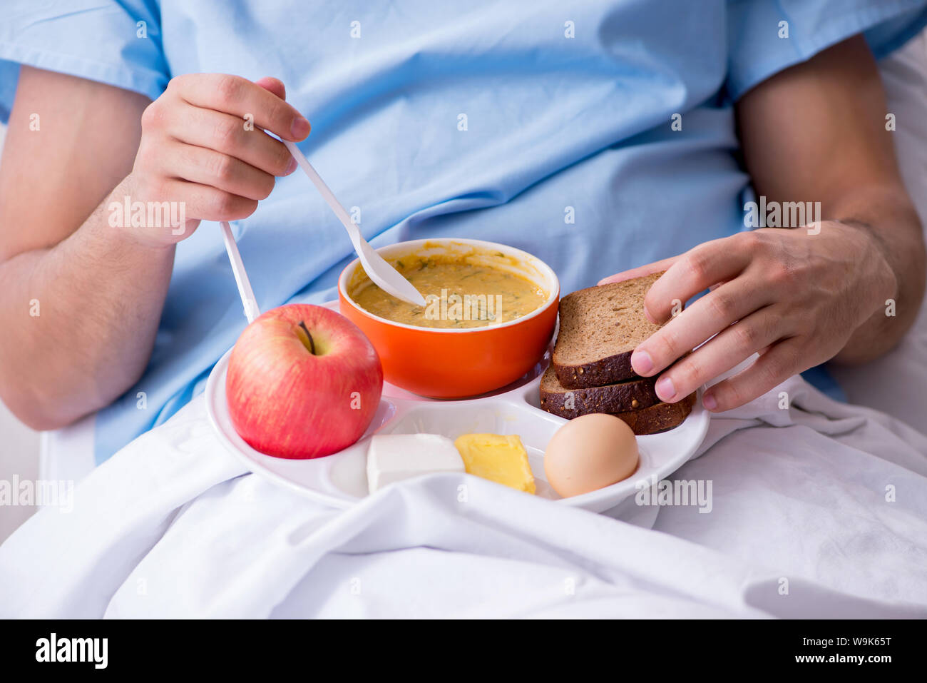 The male patient eating food in the hospital Stock Photo - Alamy