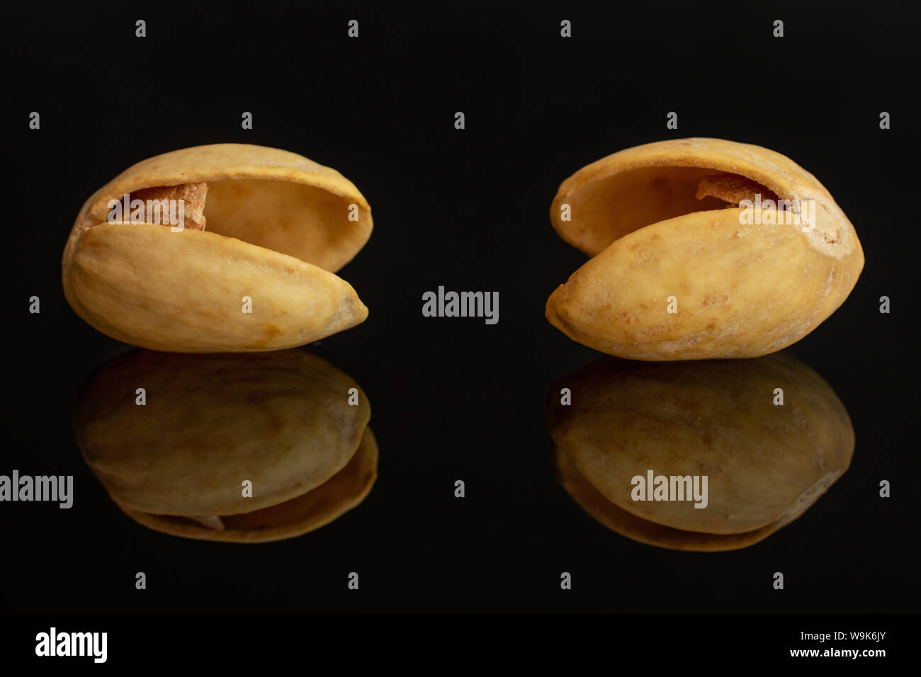 Group of two pieces of shell of ripe green pistachio in closeup ...