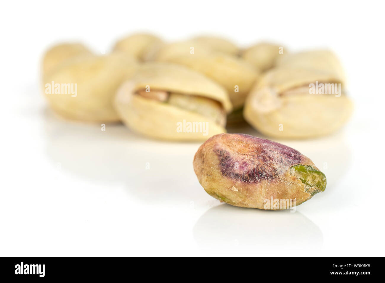 Lot of whole ripe green pistachio one is without shell in closeup ...