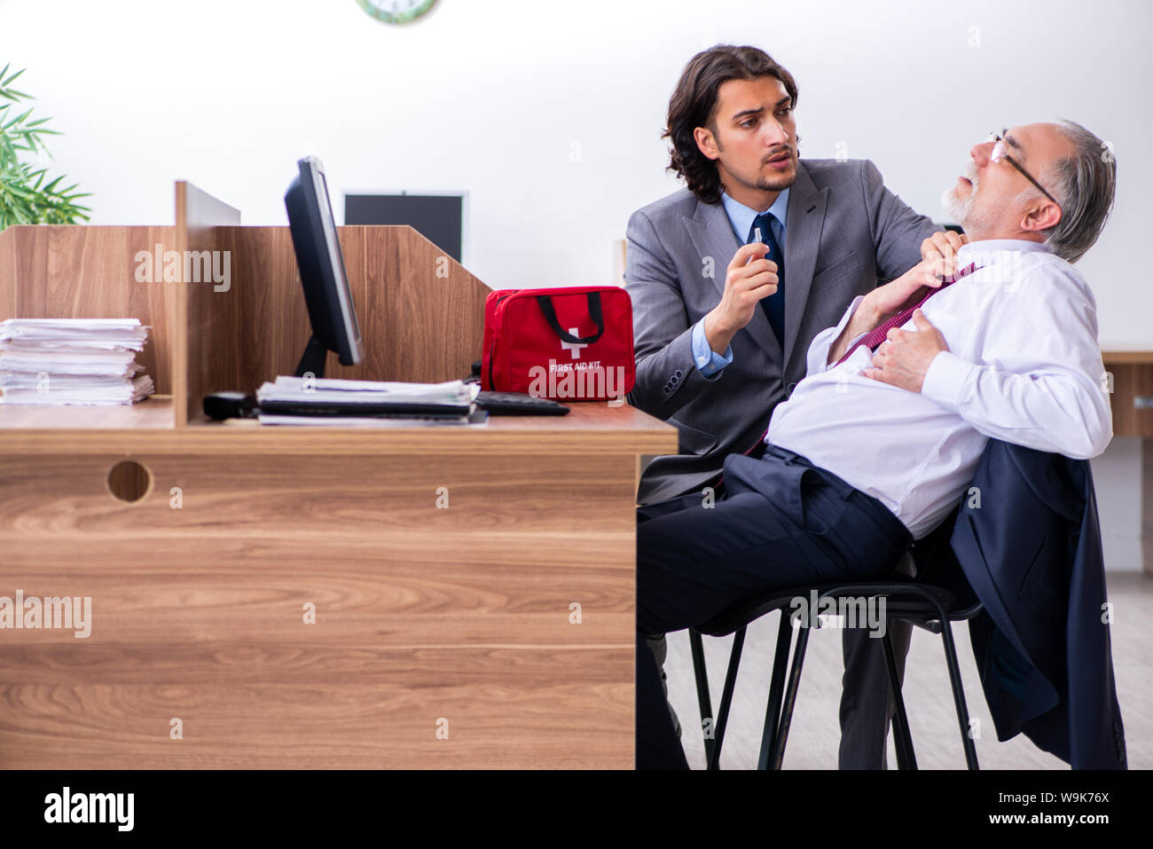 The male employee suffering from heart attack in the office Stock Photo ...