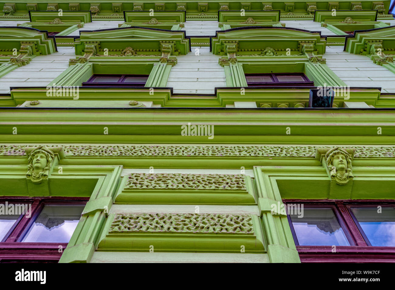 Old apartment building with a green facade Stock Photo - Alamy