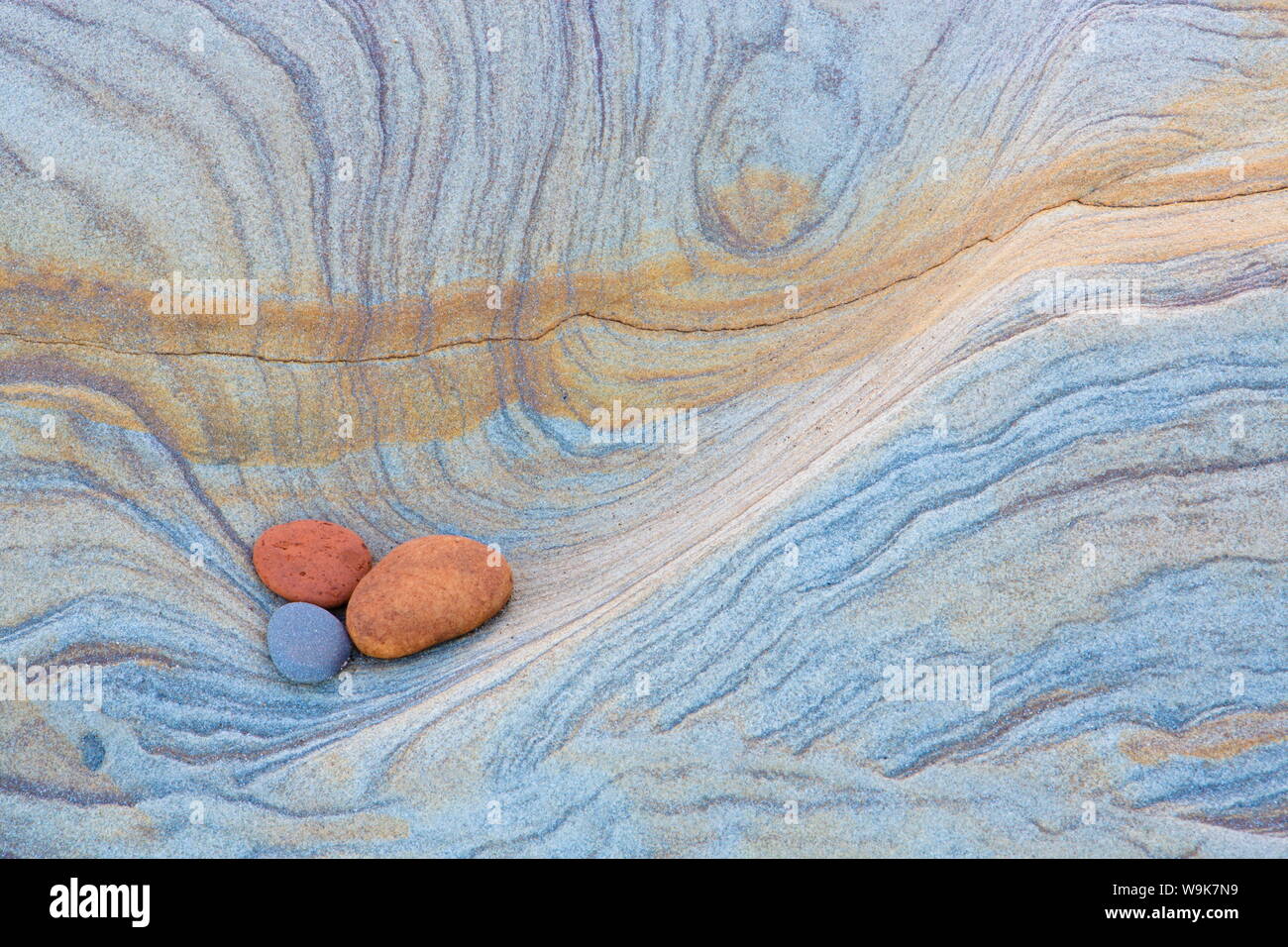 Colourful patterns created by sea erosion on rocks revealed at low tide ...