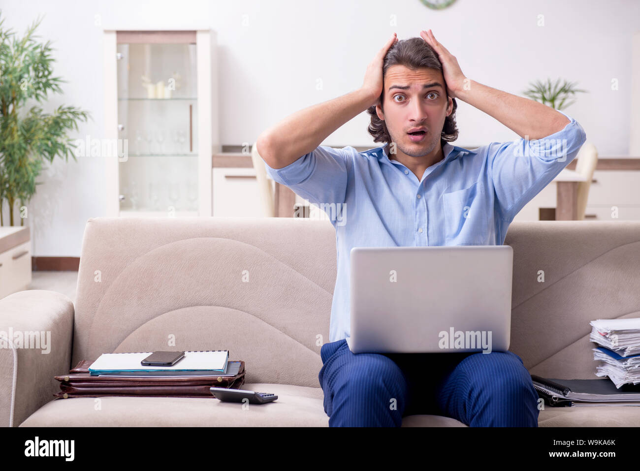 The young male employee working at home Stock Photo - Alamy