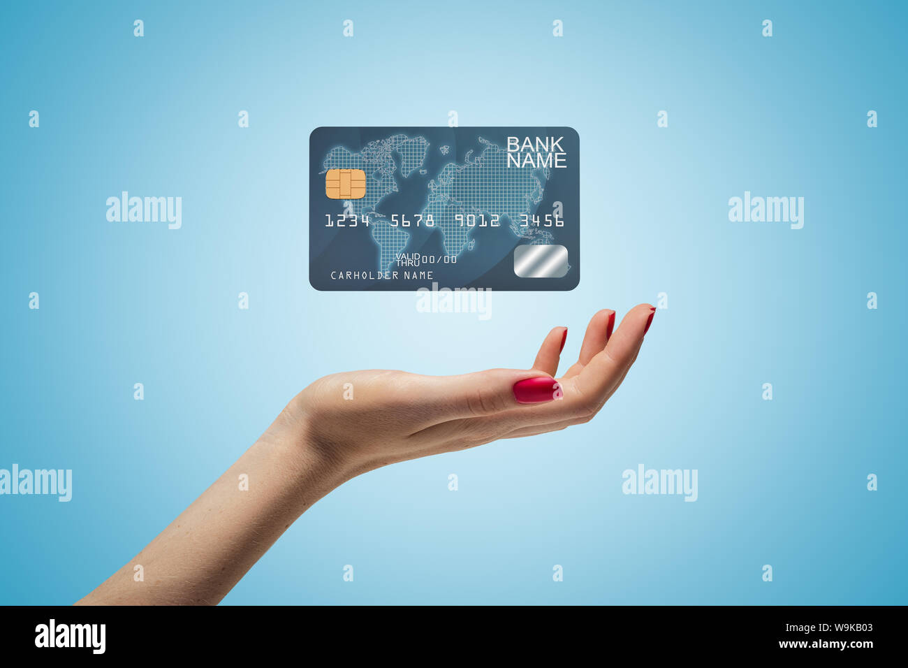 Side closeup of woman's hand facing up and levitating plastic bank card ...
