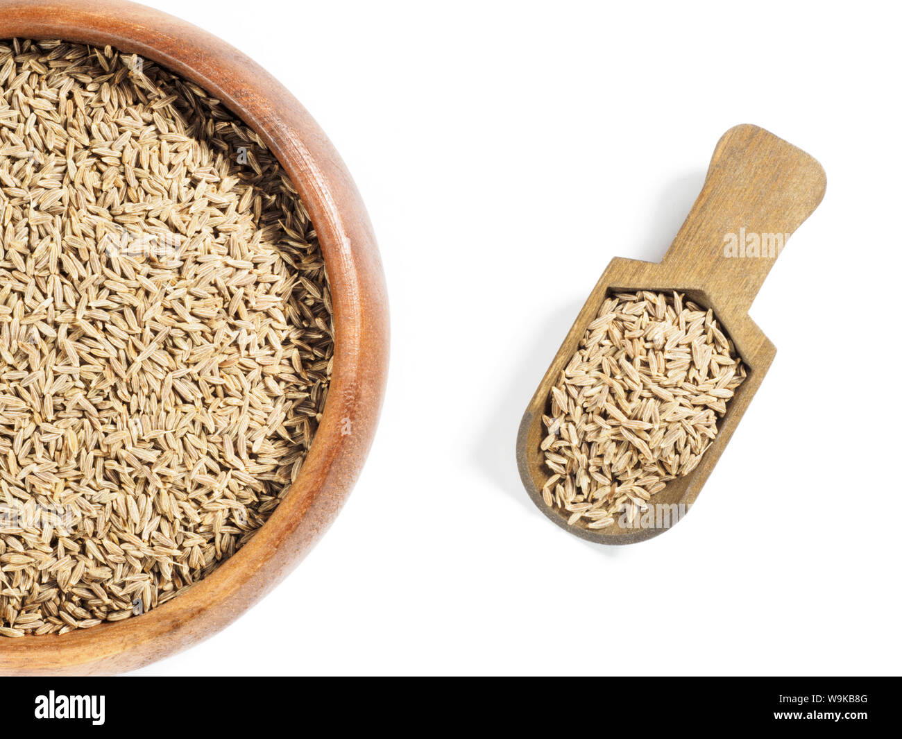 Cumin seeds (Cuminum), Jeera in a wooden cup and scoop on a white ...