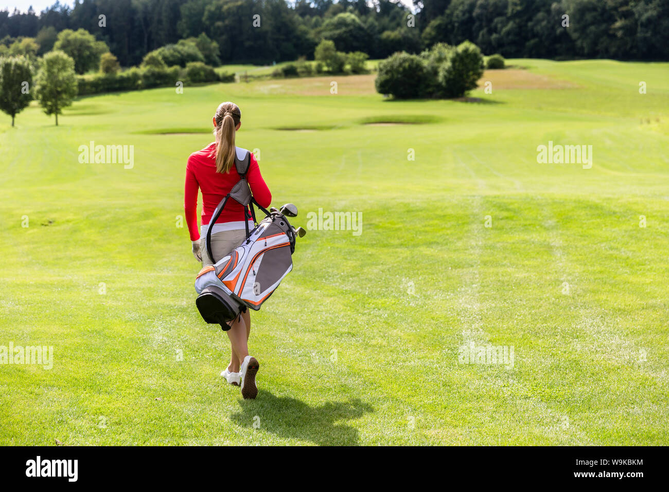 Caddy carrying golf bag hi-res stock photography and images - Alamy