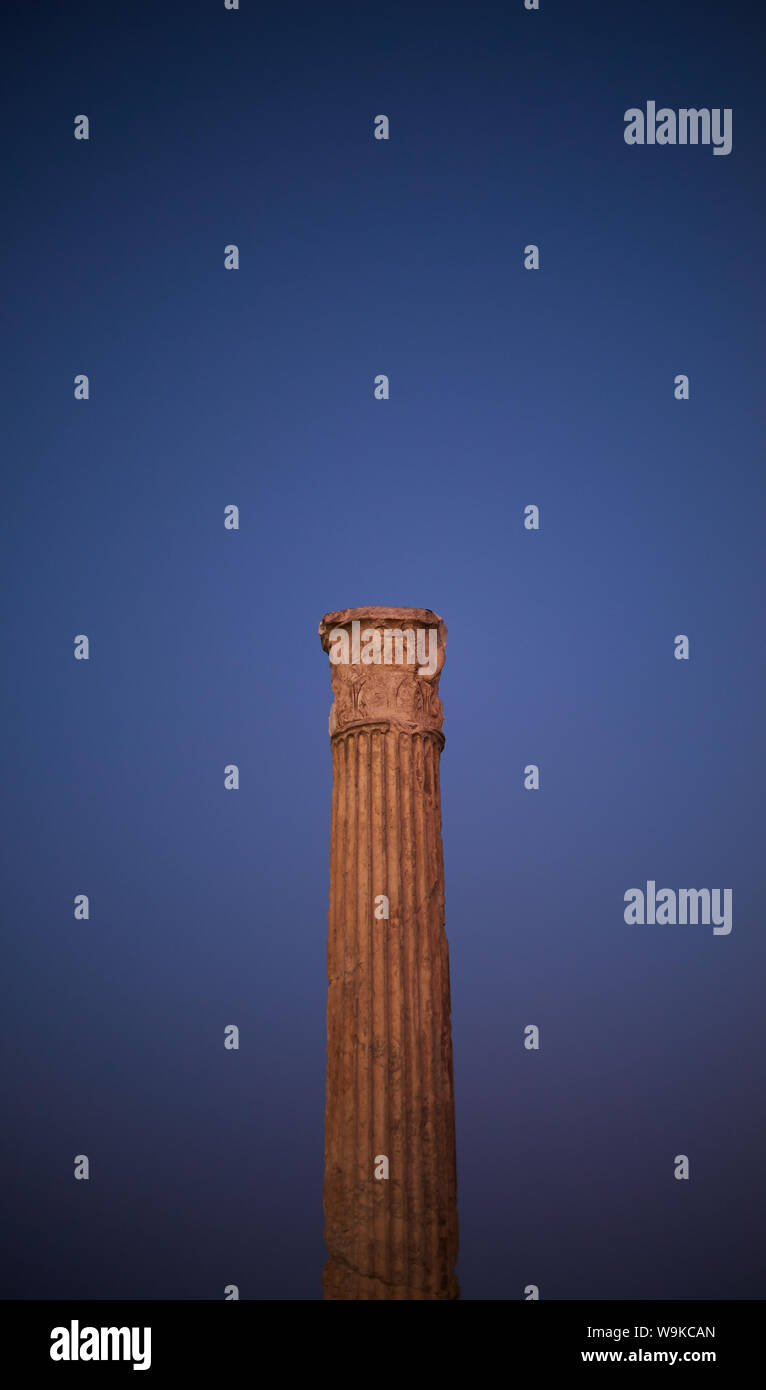 Ancient Greek pillar with blue sky at the background Stock Photo - Alamy