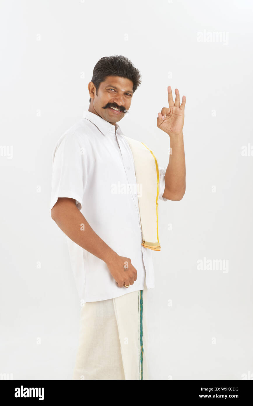 South Indian man showing OK sign and smiling Stock Photo - Alamy