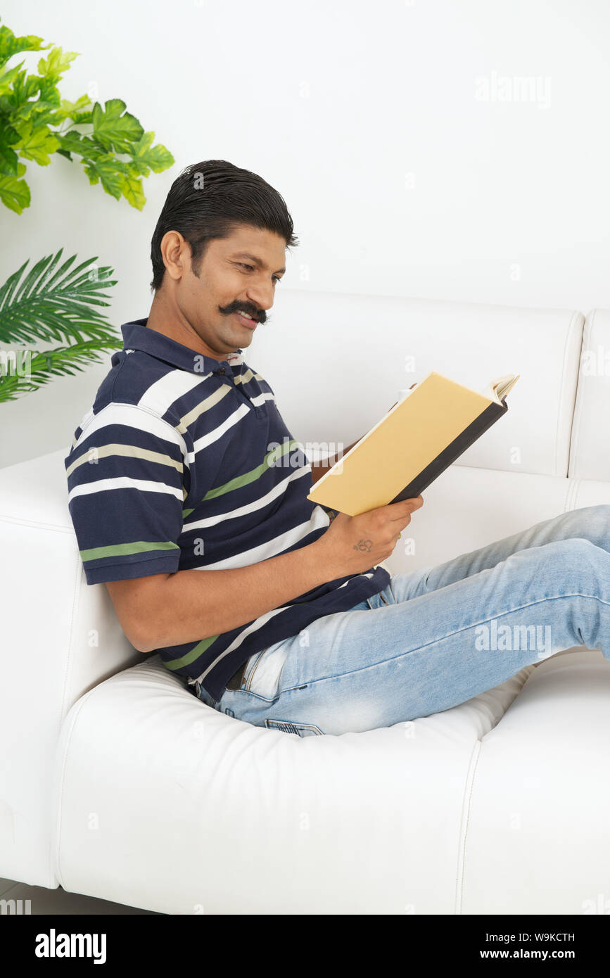 Indian man book reading reclining hi-res stock photography and images ...
