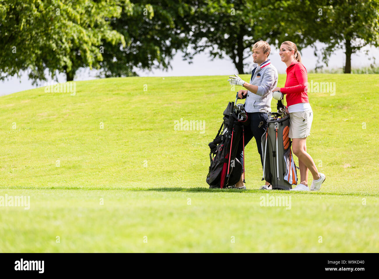 Golfing couple at golf field Stock Photo - Alamy