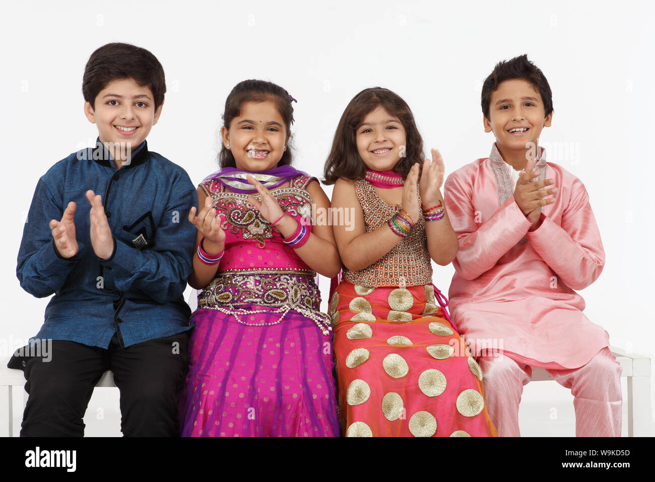 Group of friends sitting together and clapping Stock Photo - Alamy