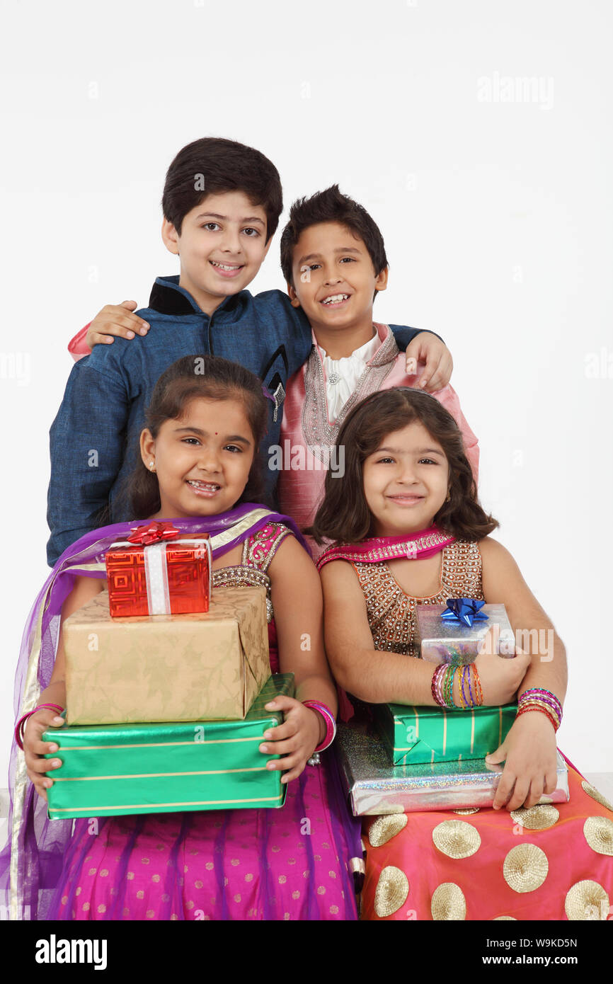 Group of children holding gift boxes and smiling Stock Photo - Alamy