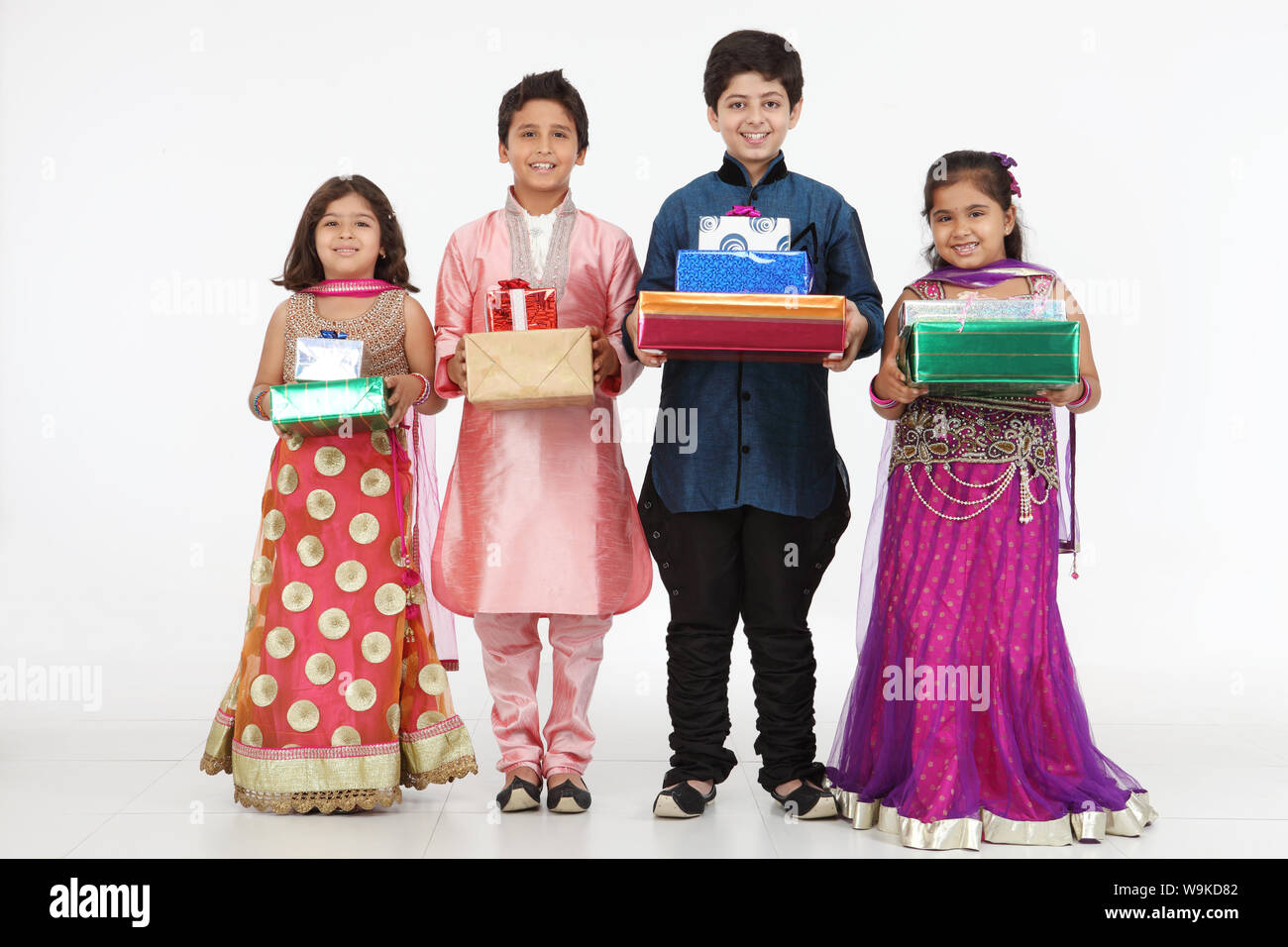 Group of children standing together and holding gift boxes Stock Photo ...