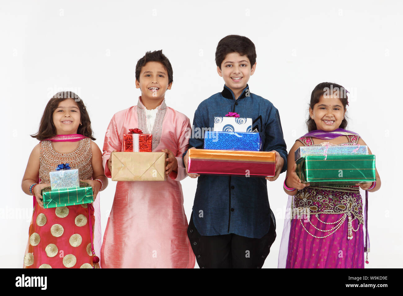 Group of children standing together and holding gift boxes Stock Photo ...