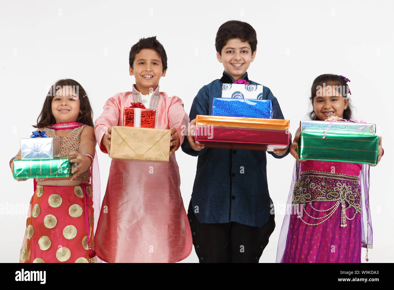 Group of children standing together and holding gift boxes Stock Photo ...