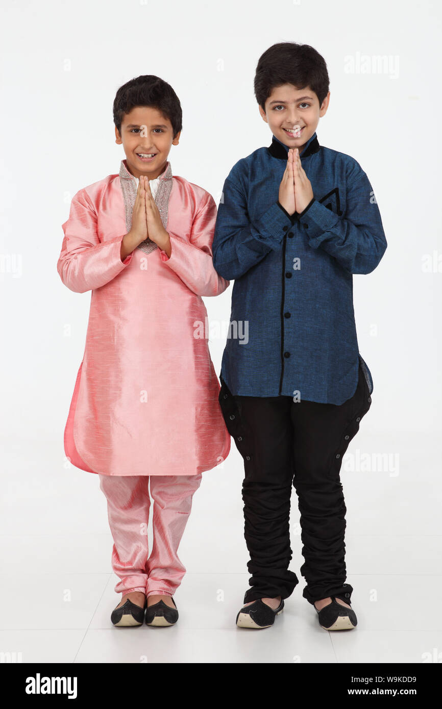 Two boys greeting with hands joined Stock Photo - Alamy