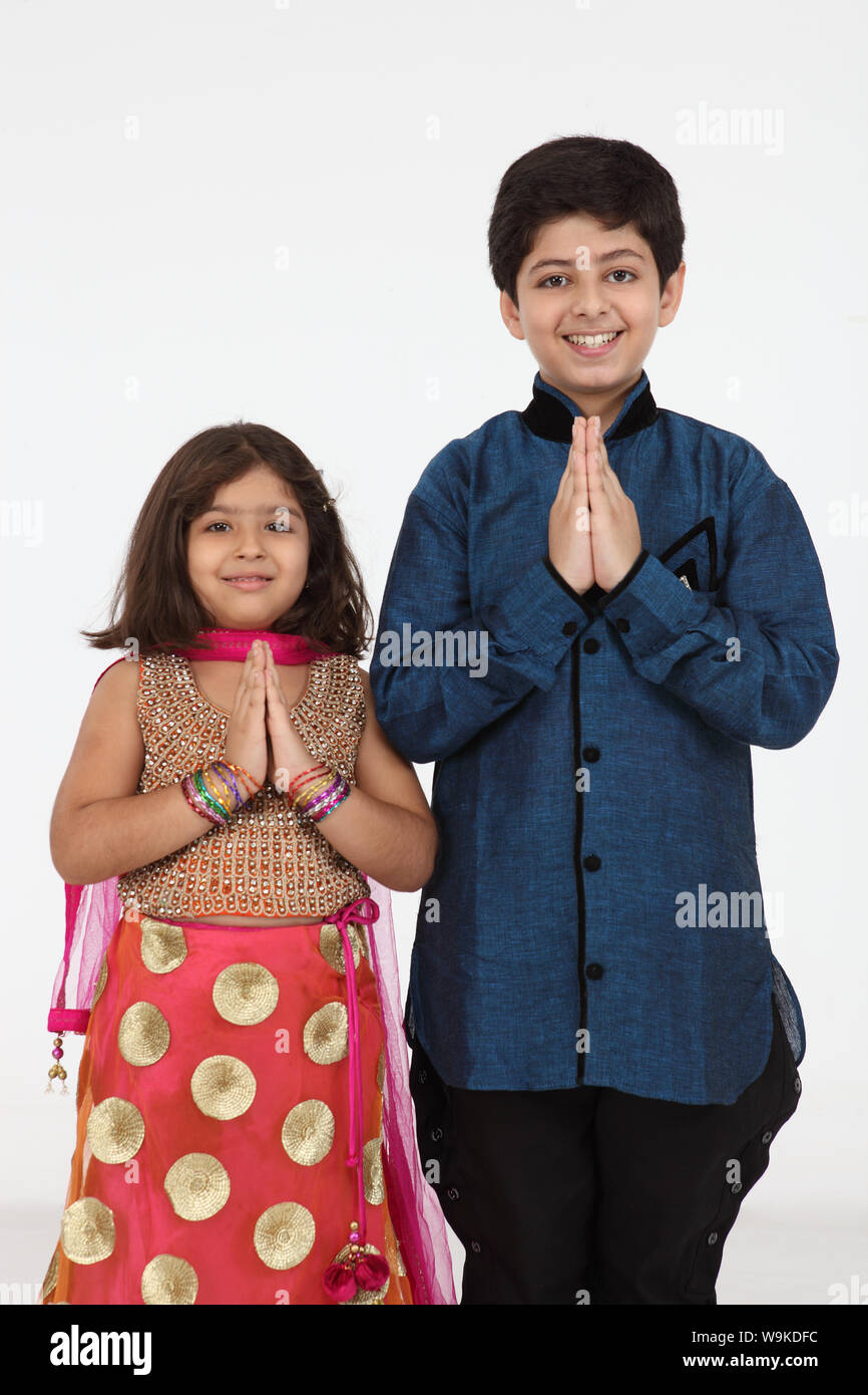 Two children greeting with hands joined Stock Photo - Alamy