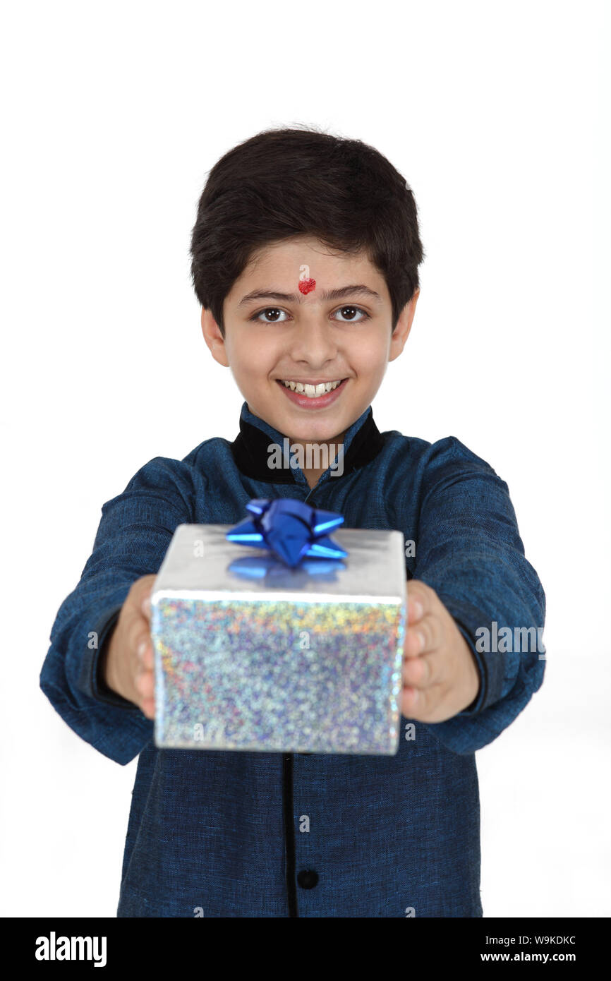 Boy giving a gift box and smiling Stock Photo - Alamy