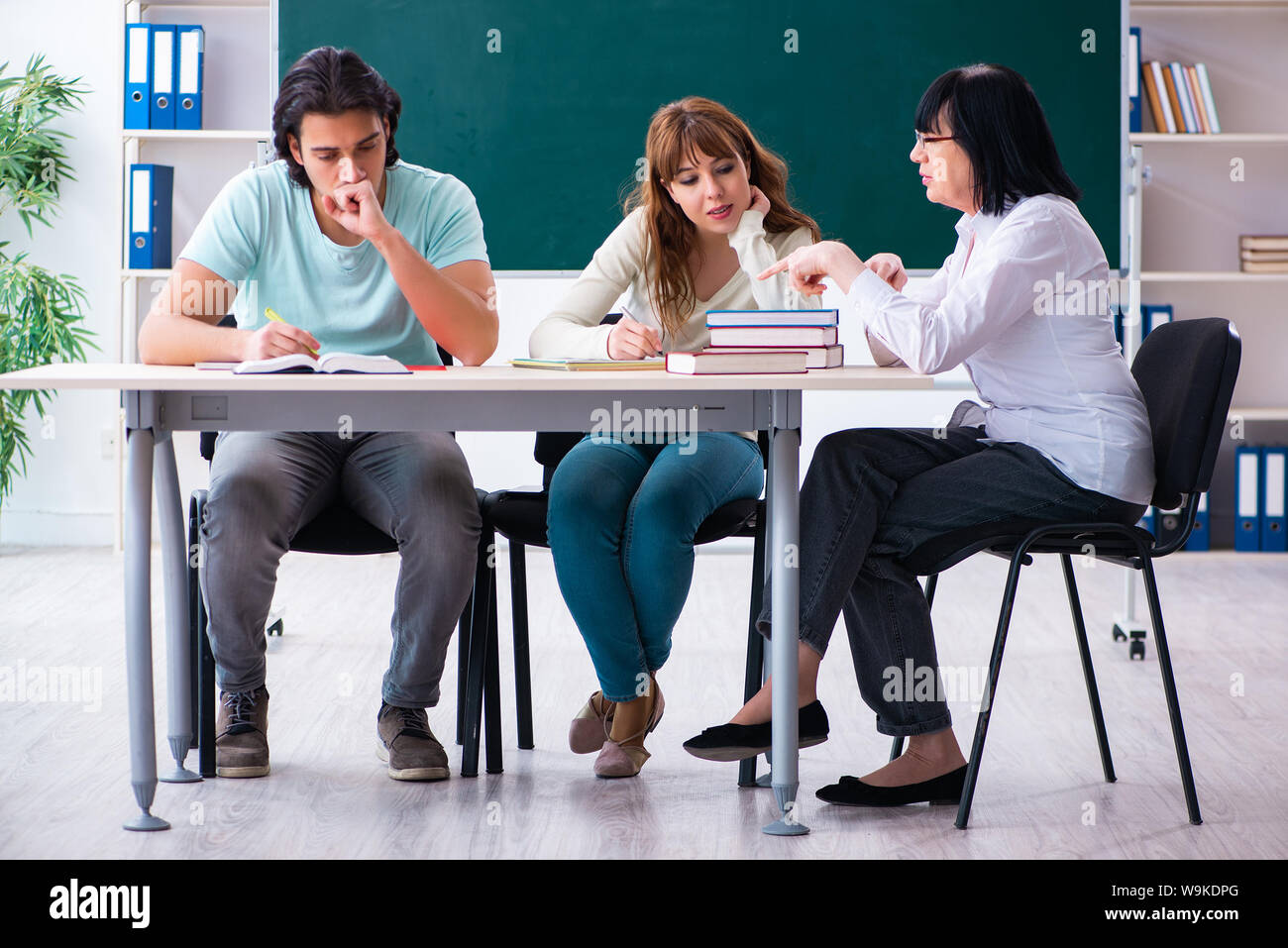 The old teacher and students in the classroom Stock Photo - Alamy