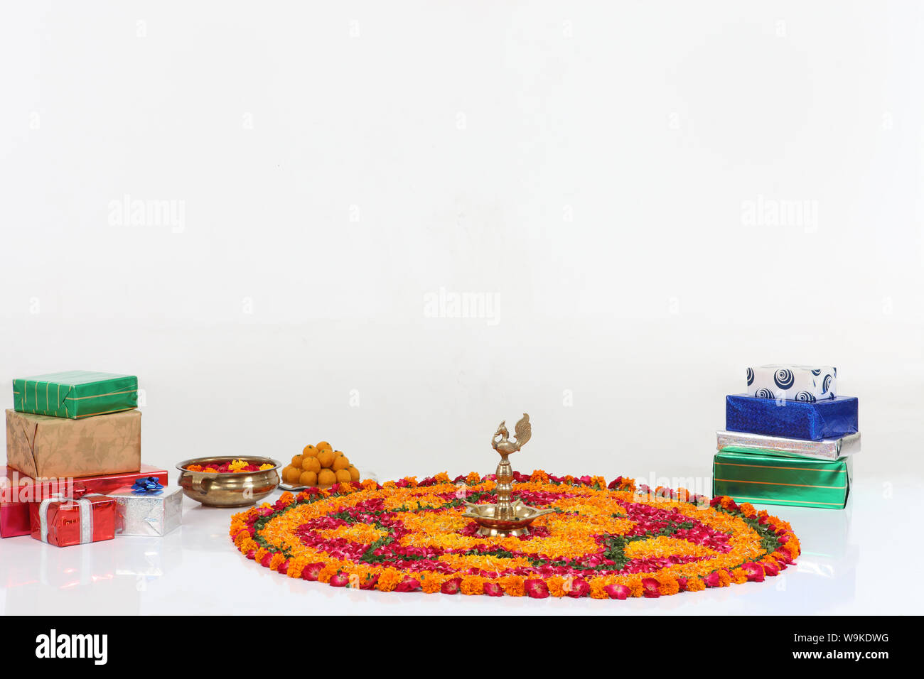 Colorful rangoli on the floor with gift boxes Stock Photo - Alamy