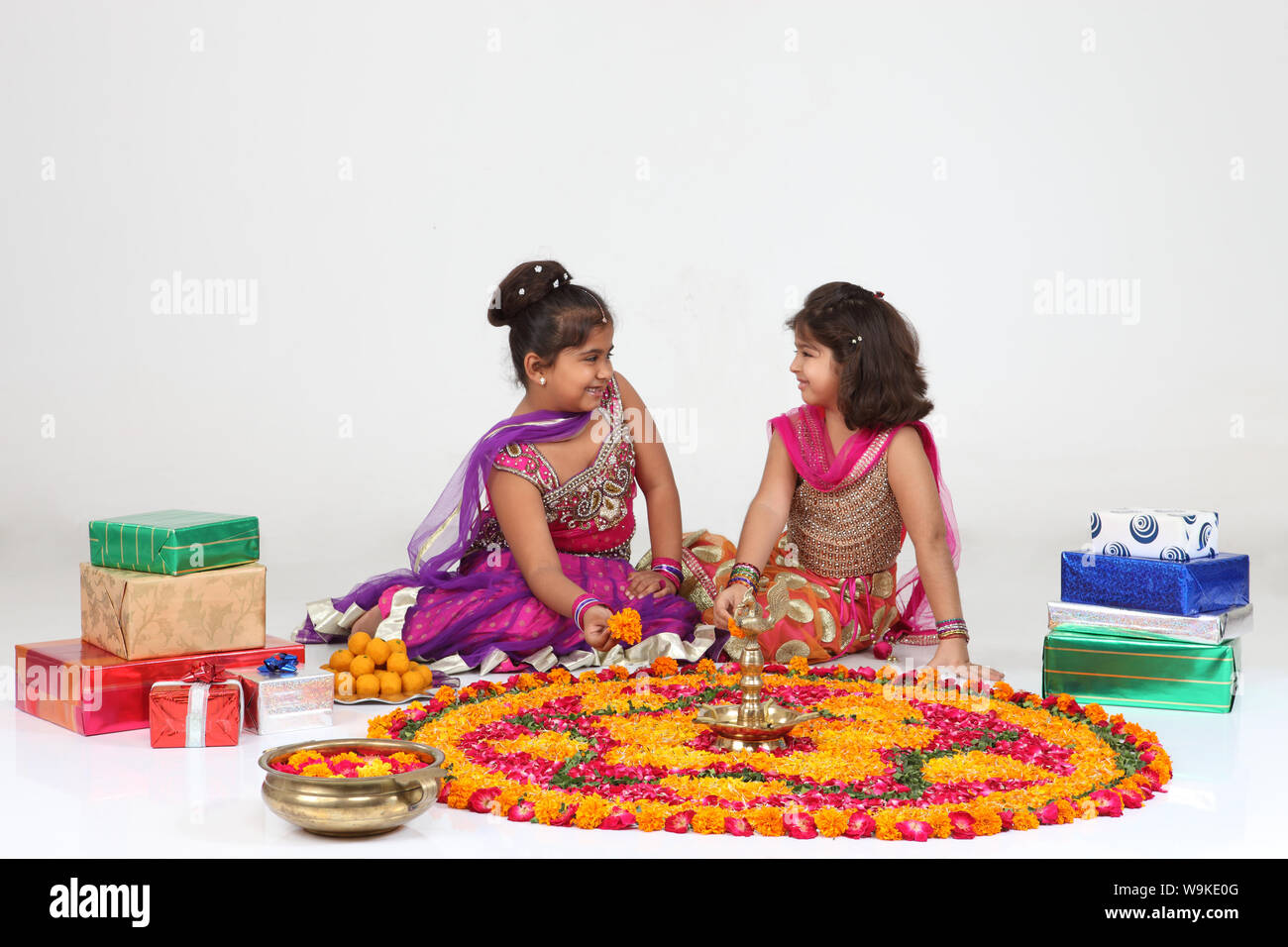 Two girls making rangoli Stock Photo - Alamy