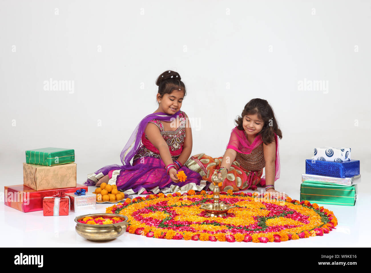 Two girls making rangoli Stock Photo - Alamy