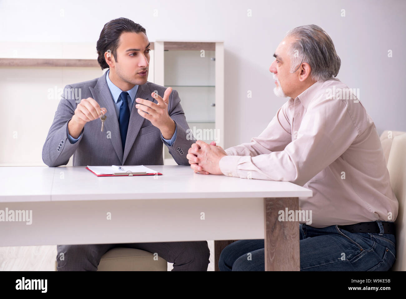 The male real estate agent and male client in the apartment Stock Photo ...