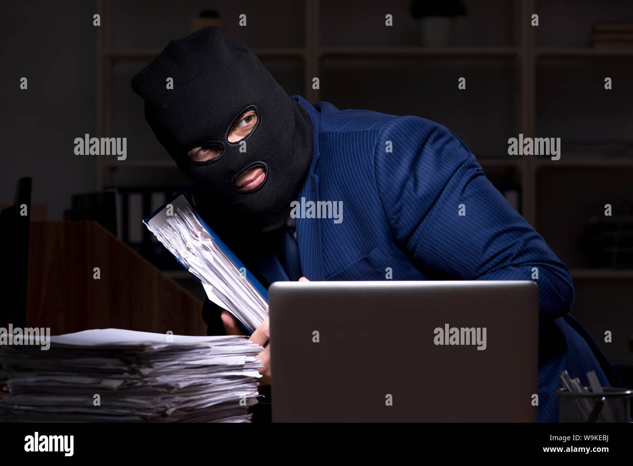 The male employee stealing information in the office night time Stock ...