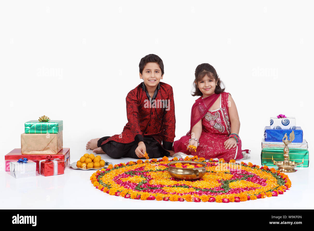 Two children making rangoli Stock Photo - Alamy