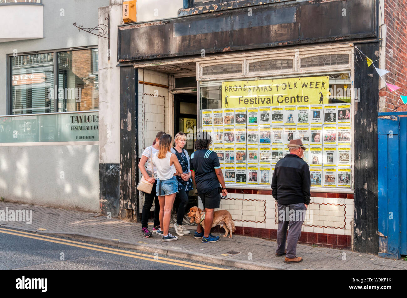 People looking at posters in the window of the Broadstairs Folk Week ...