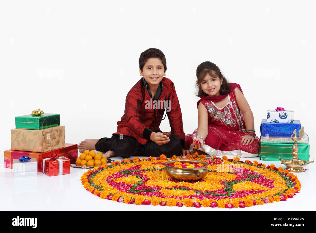 Two children making rangoli Stock Photo - Alamy