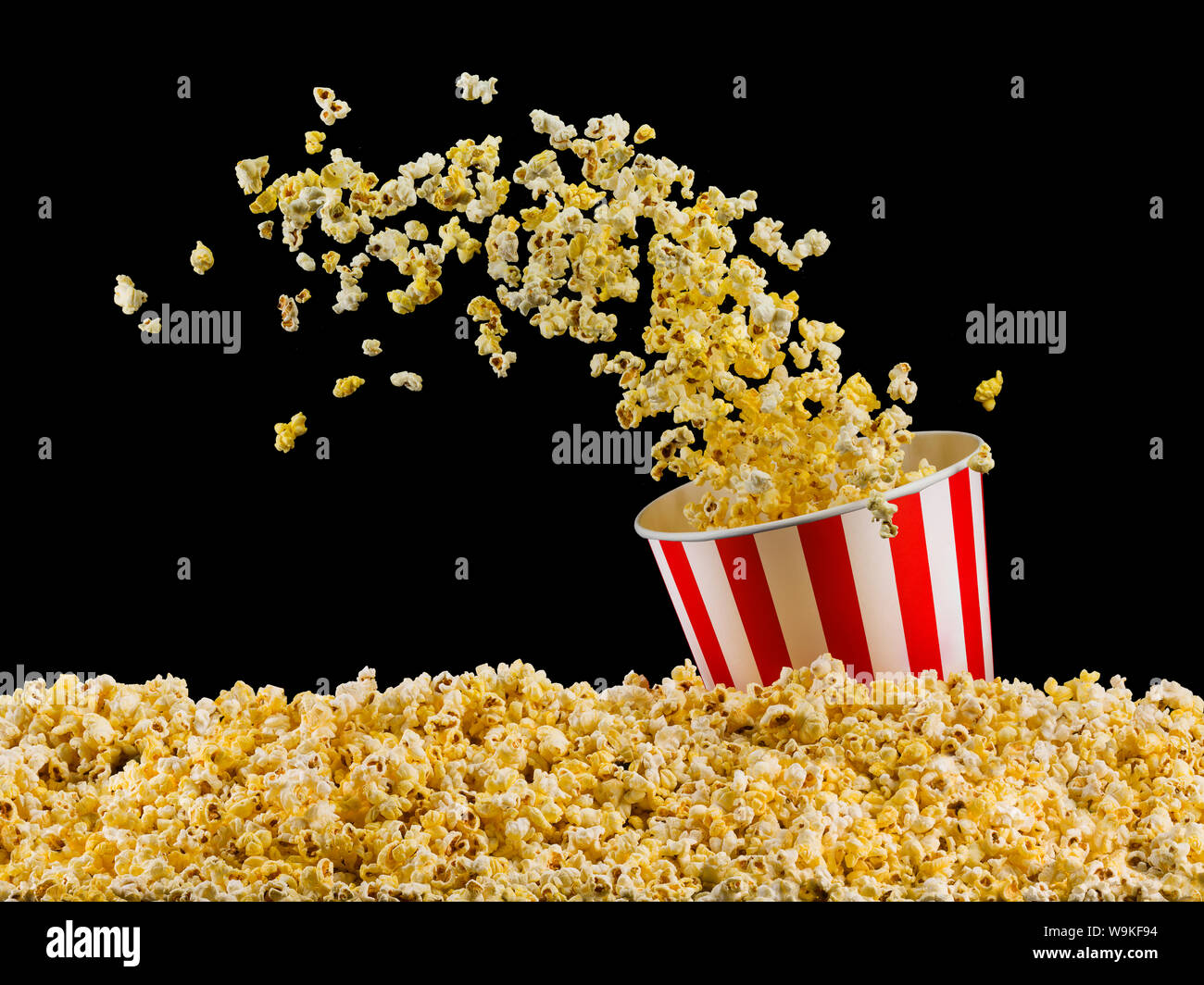 Flying popcorn from striped bucket isolated on black background Stock ...