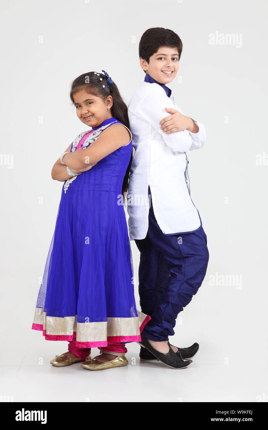 Two children standing back to back and smiling Stock Photo - Alamy
