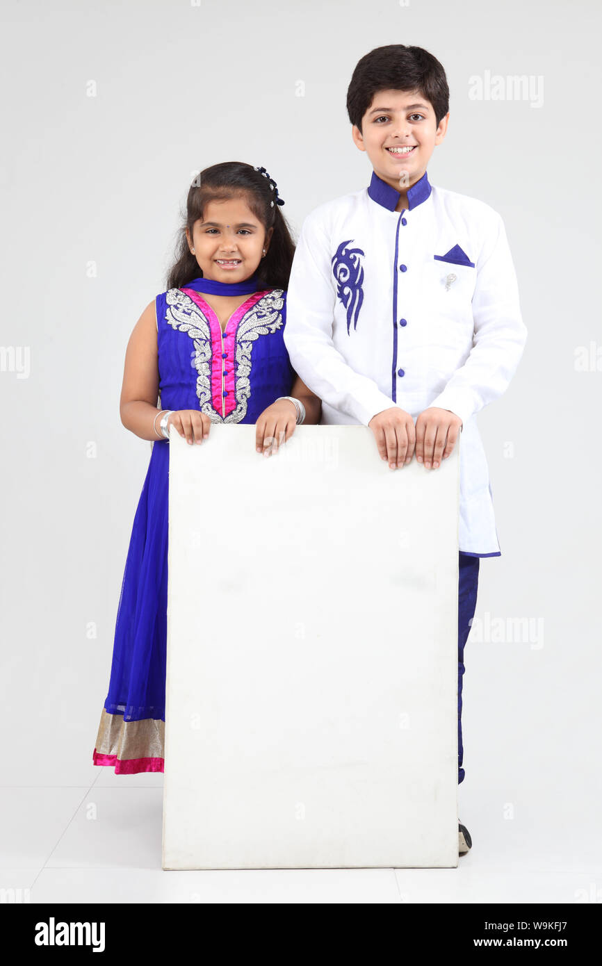 Two children showing a placard and smiling Stock Photo - Alamy