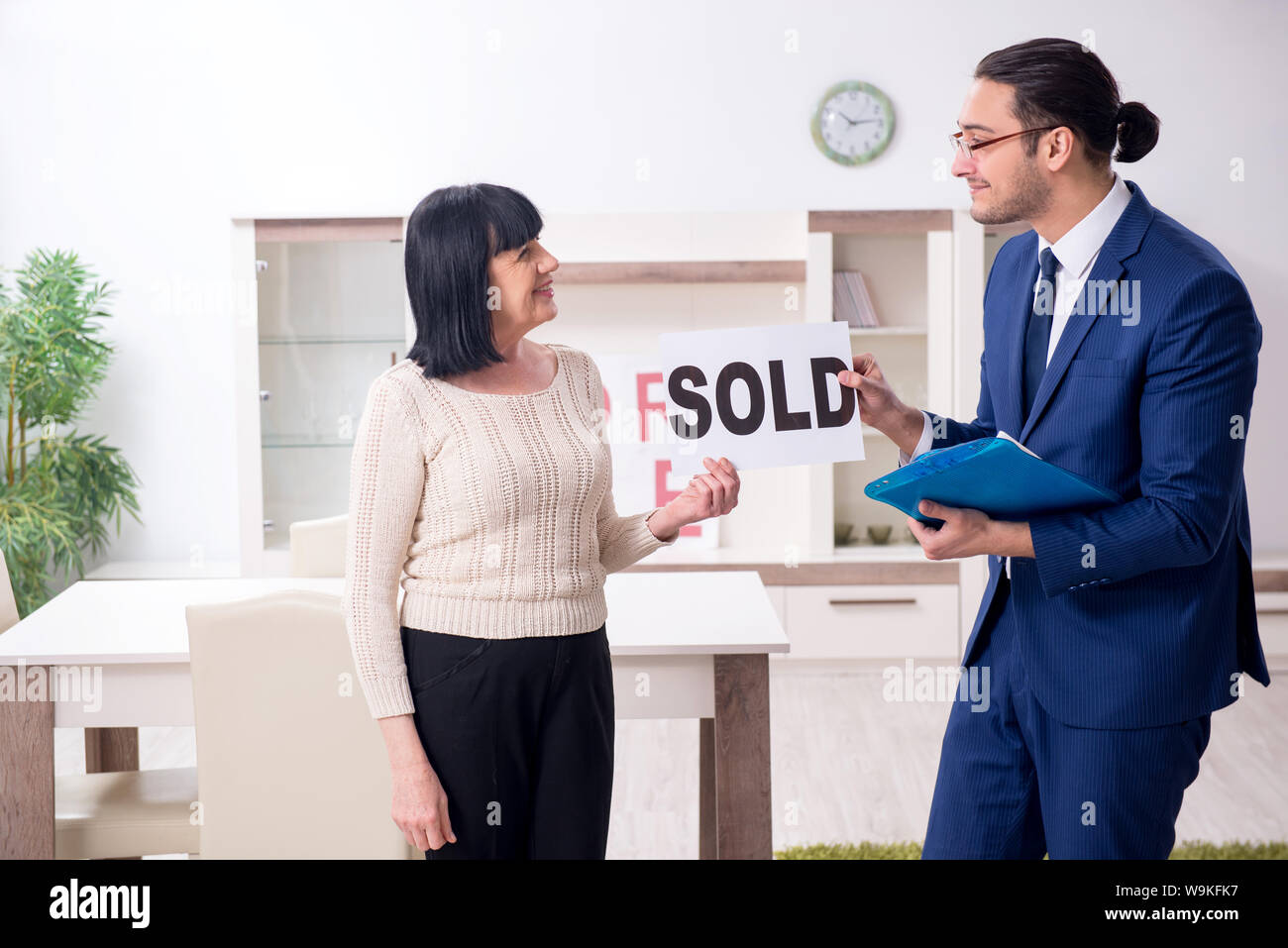 The male real estate agent and female client in the apartment Stock ...